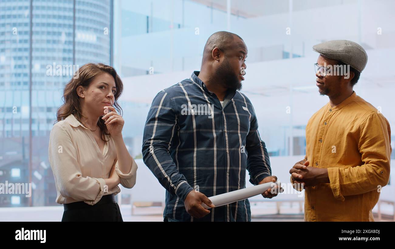 Realtor and business entrepreneur examining blueprints for a high class ...