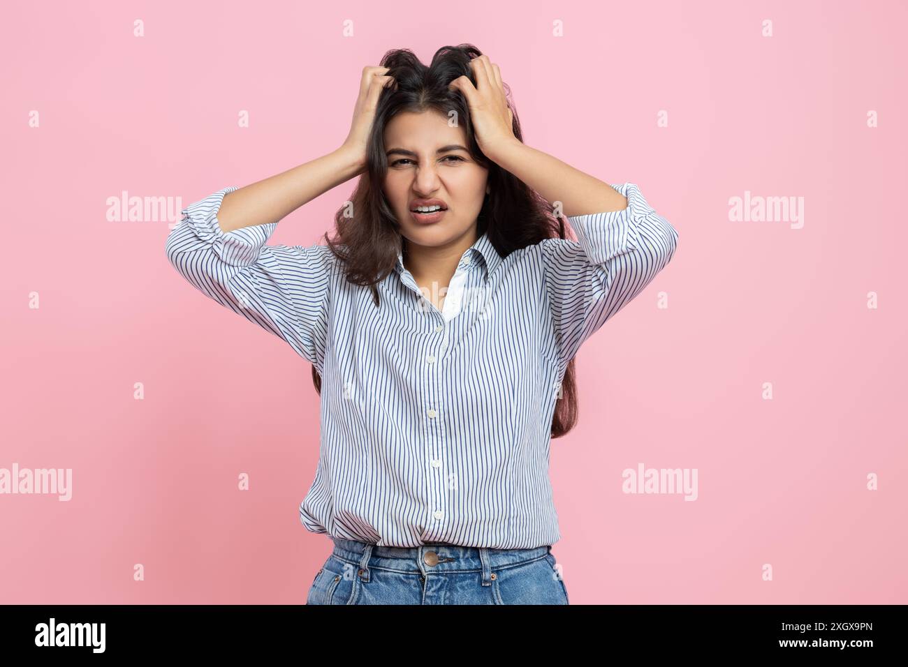 Irritated Indian woman screaming with despair keeps hands on head Stock ...