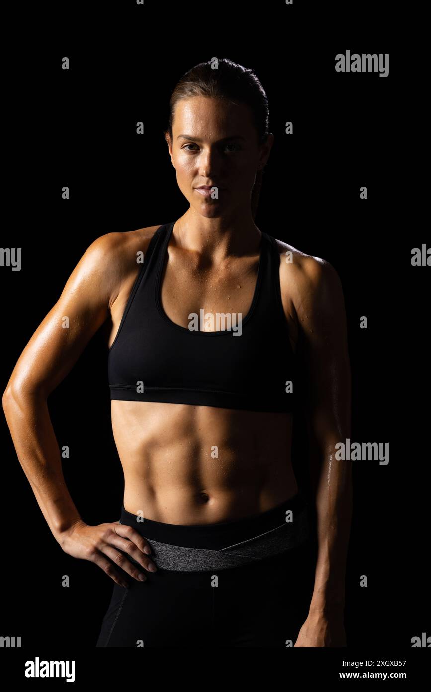 Fit young Caucasian female athlete poses confidently in sportswear ...