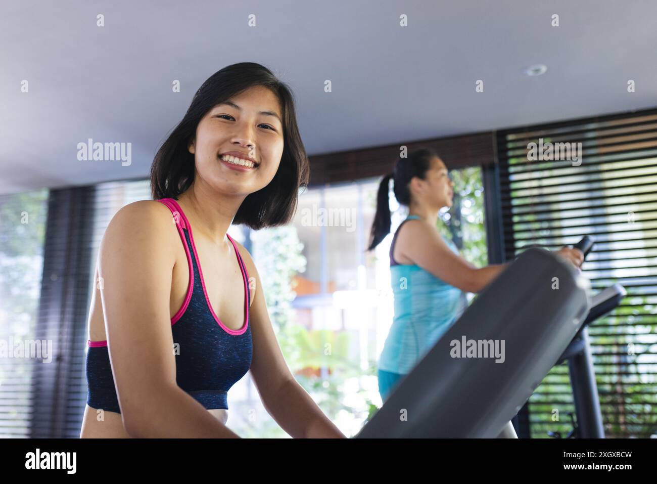 Portrait of happy asian female friends wearing sports clothes and ...