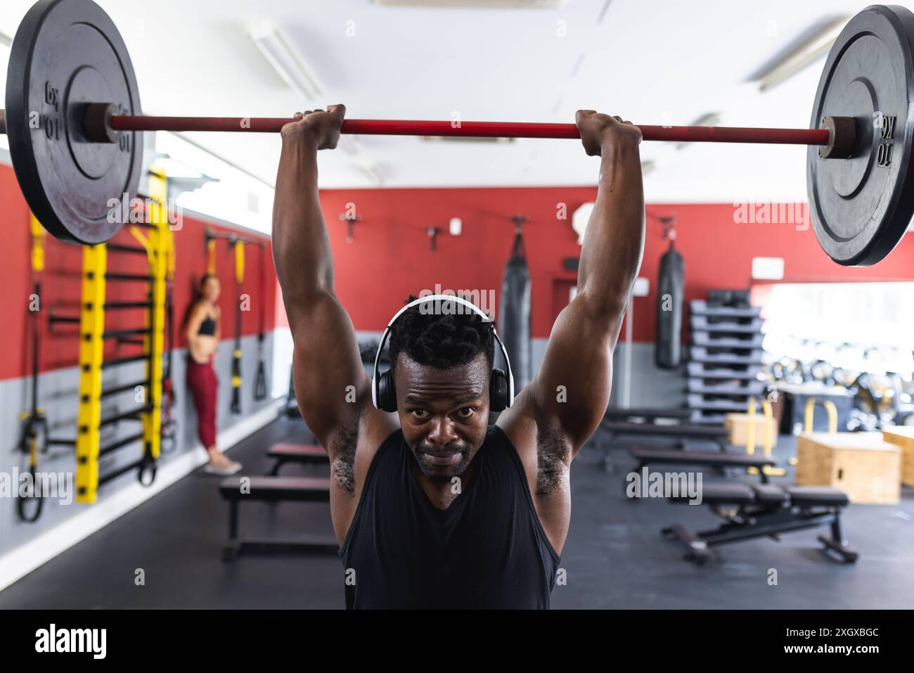 Fit African American man lifting weights at the gym, with copy space ...