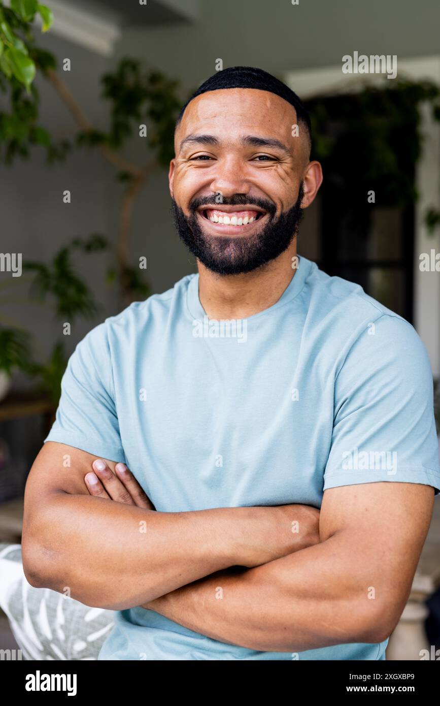 Young biracial man smiling confidently at home, with copy space ...