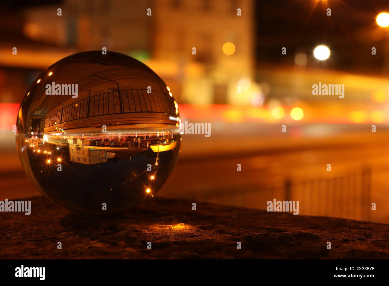 Beautiful city street, overturned reflection. Crystal ball at night ...