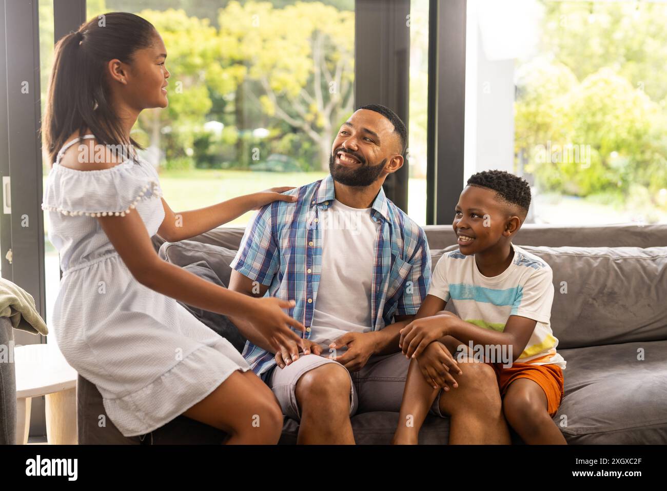 Teenage biracial girl and African American boy, siblings, enjoy time at ...