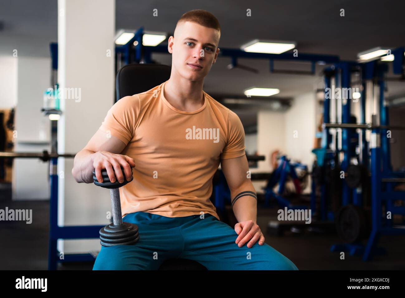 Bodybuilder sits holds dumbbell hi-res stock photography and images - Alamy