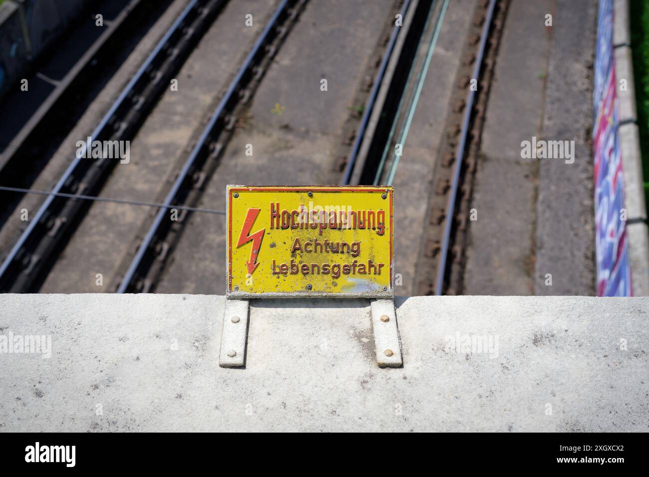 yellow sign with red inscription in german high voltage attention ...