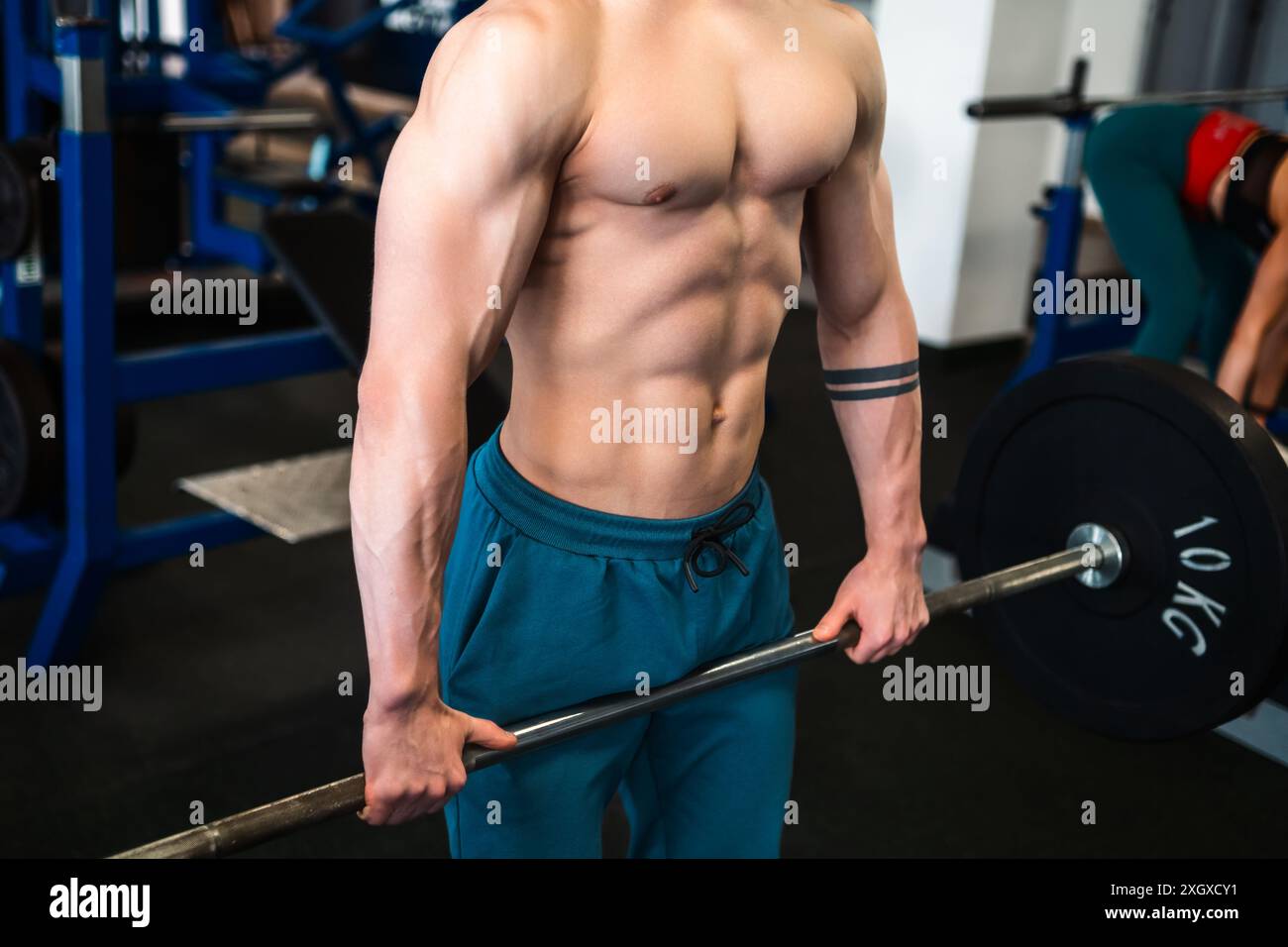 Muscular man lifts a barbell in the gym. Bodybuilding and powerlifting ...