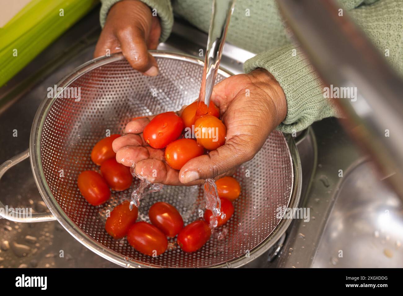 African american female washing tomatoes hi-res stock photography and ...