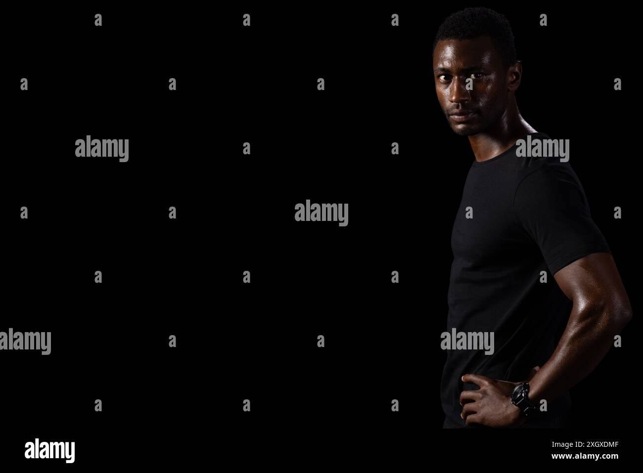 African American man poses confidently against a dark background on ...