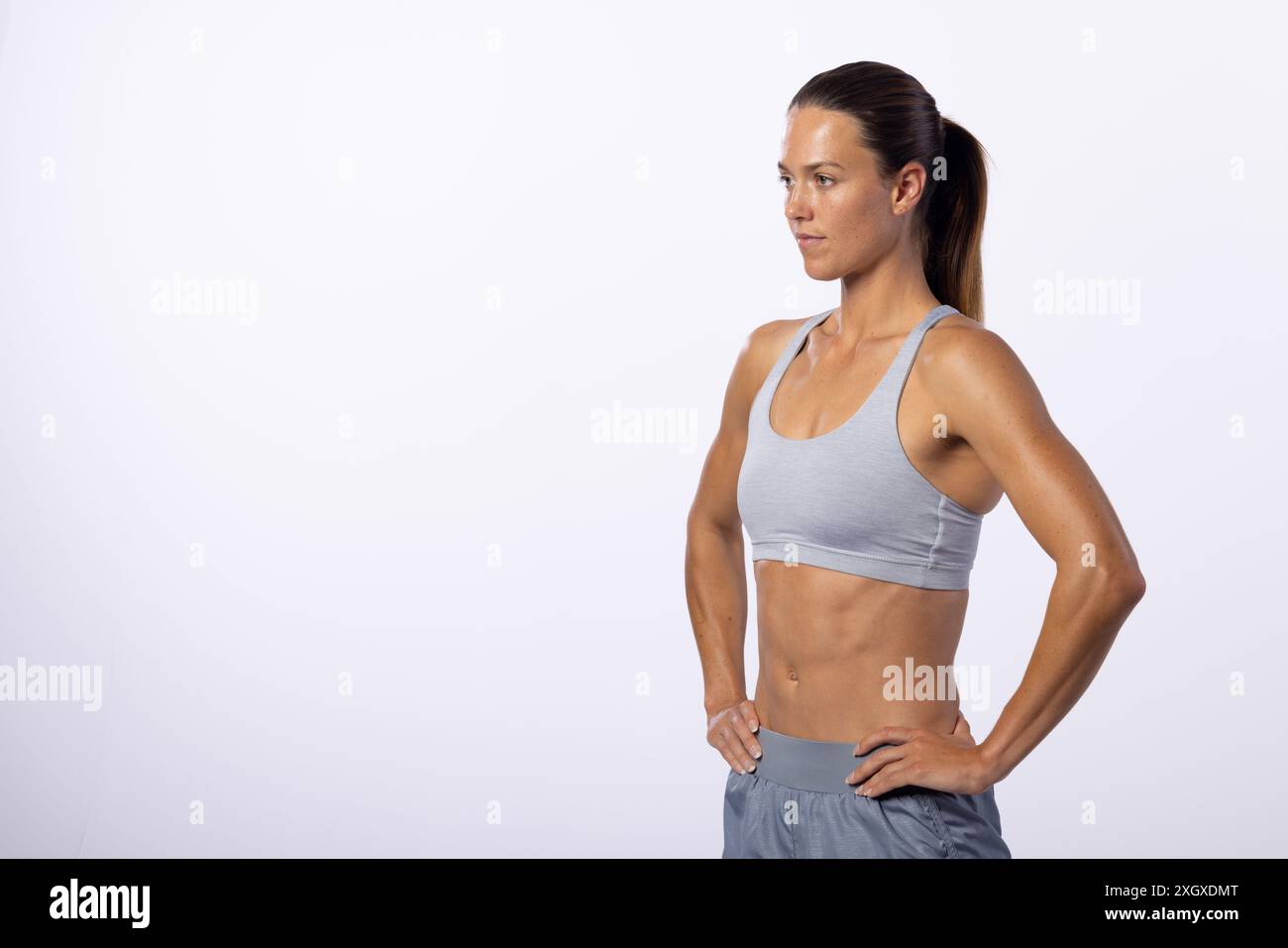 Young Caucasian female athlete stands confidently with copy space in a ...