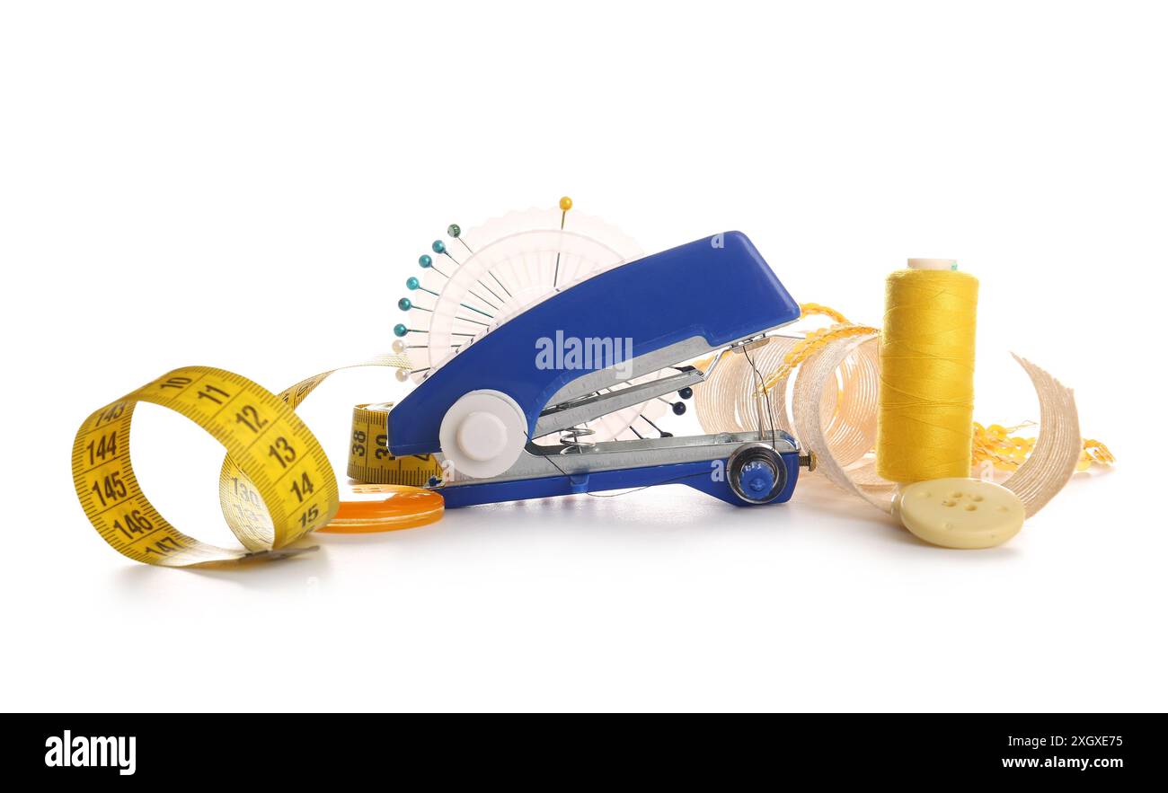 Manual sewing machine with set of tailor's supplies isolated on white ...