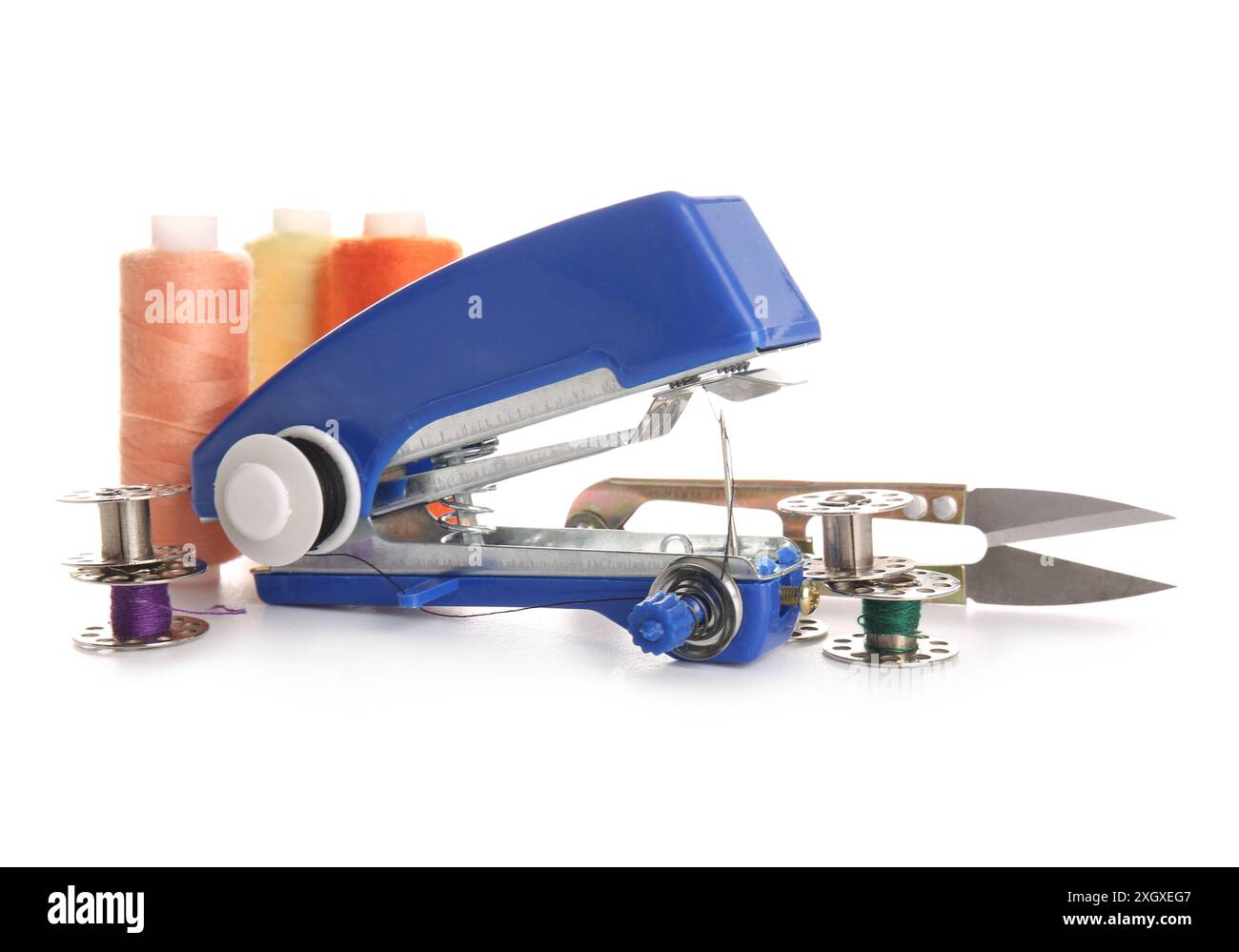 Manual sewing machine with thread cutter and spools isolated on white ...