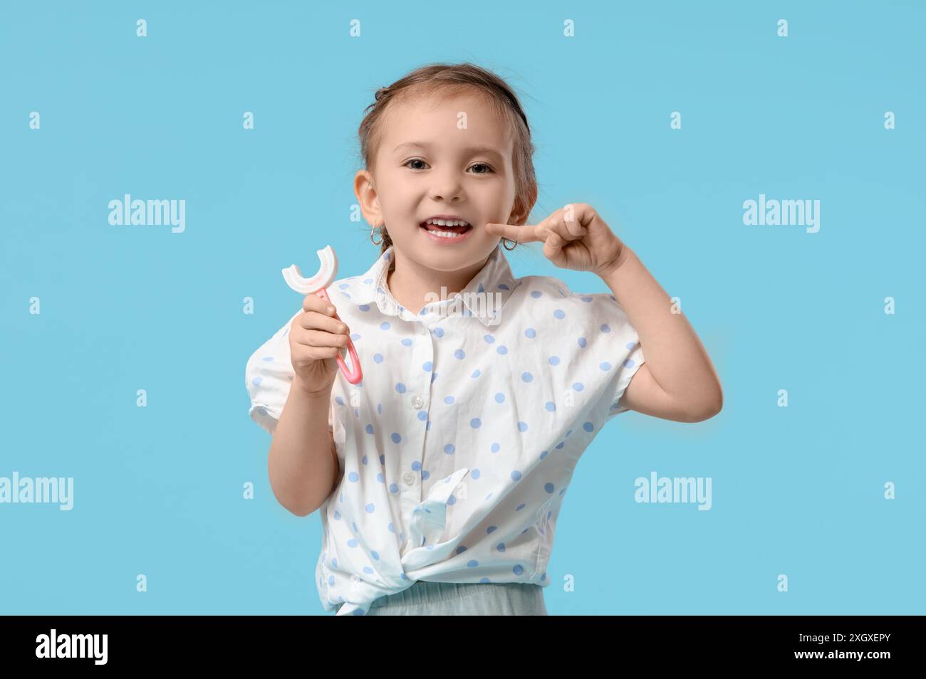 Happy cute little girl with toothbrush on blue background Stock Photo ...