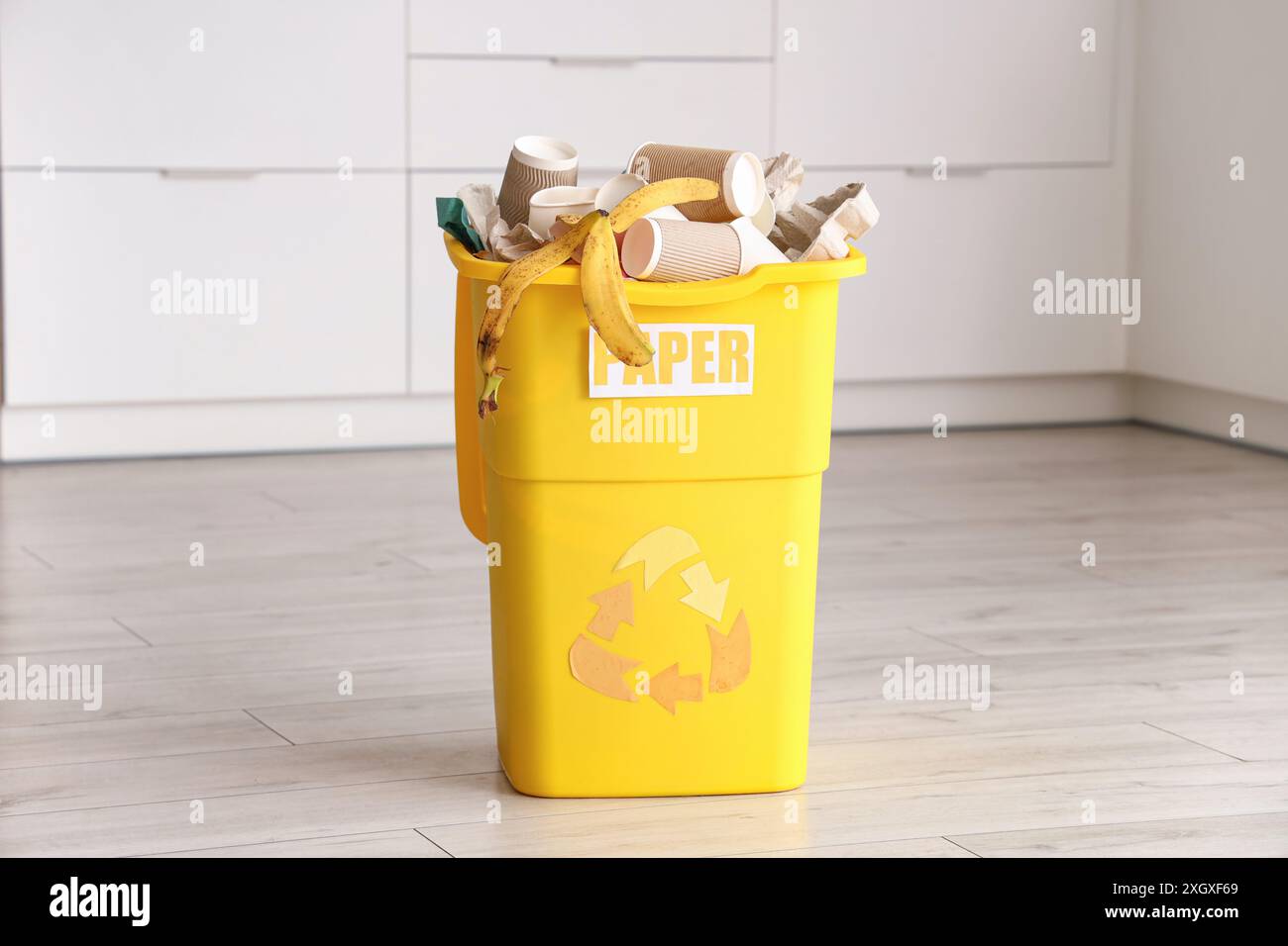 Full trash bin with PAPER sign in kitchen. Recycling concept Stock ...