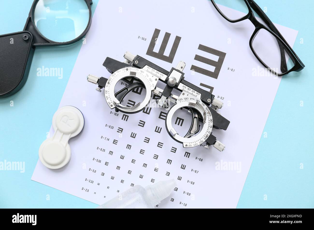 Optical trial frame with eye test chart, eyeglasses and magnifier on ...