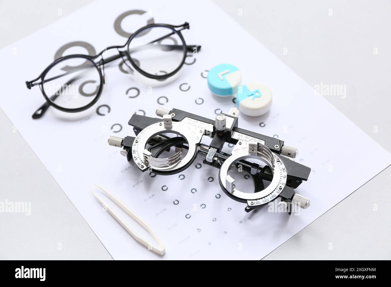 Optical trial frame with eye test chart, eyeglasses and container for ...