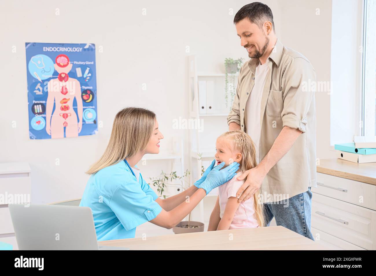 Female endocrinologist examining thyroid gland of little girl and her ...