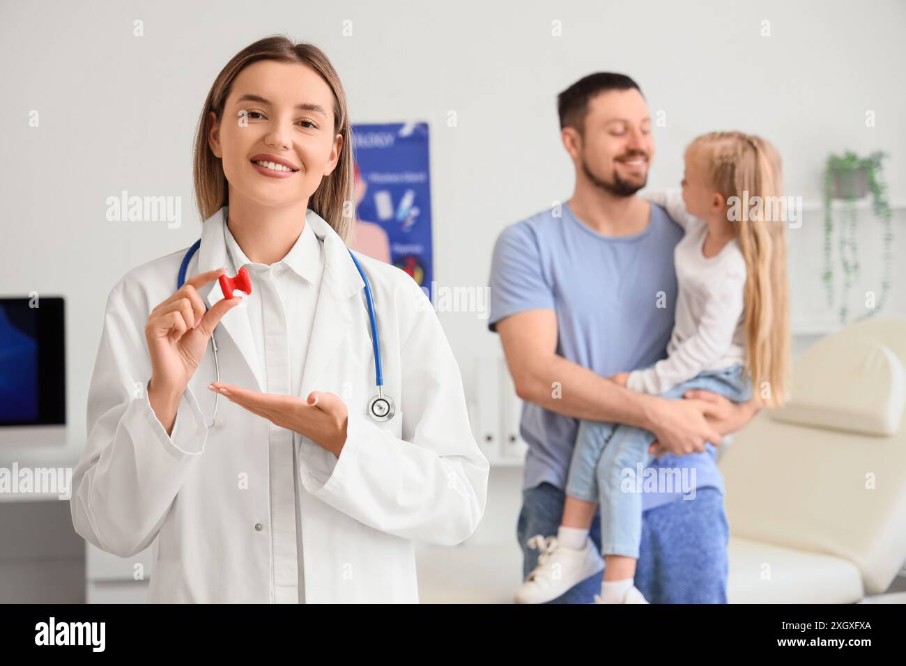Female endocrinologist with thyroid gland model in clinic Stock Photo ...