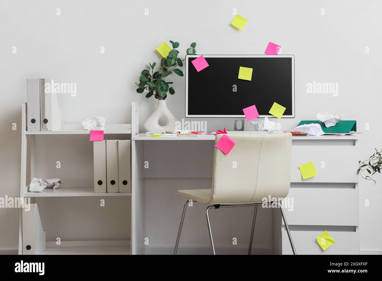 Messy workplace with computer monitor and sticky notes in light office ...