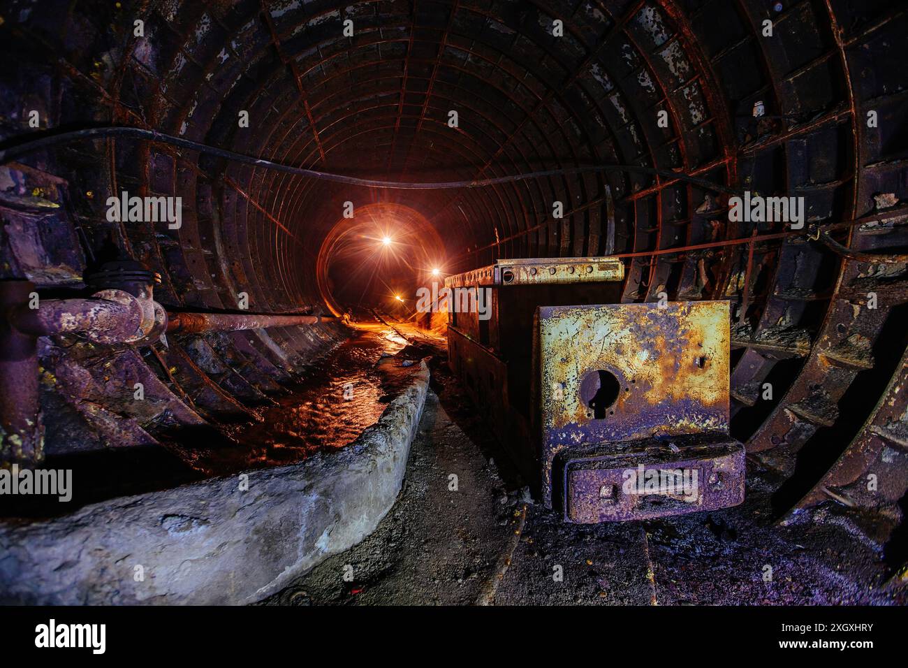 Old abandoned subway construction tunnel with rusty trolley locomotive ...