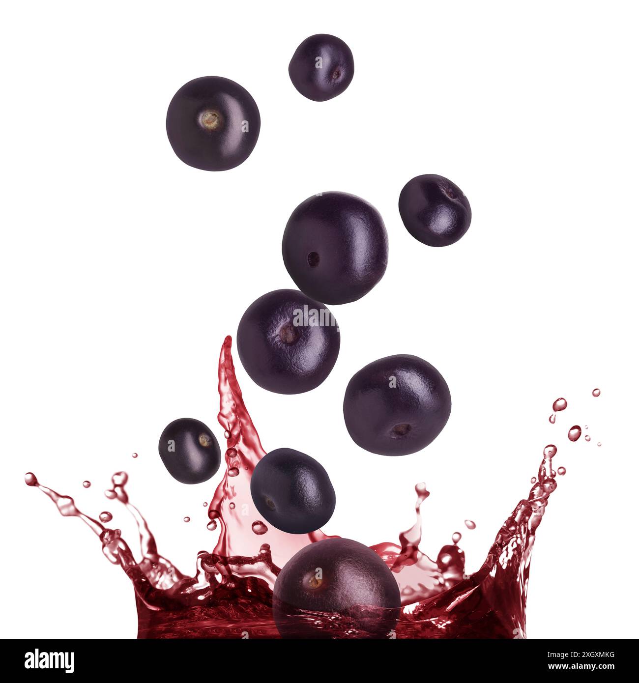 Acai berries falling into juice on white background Stock Photo - Alamy