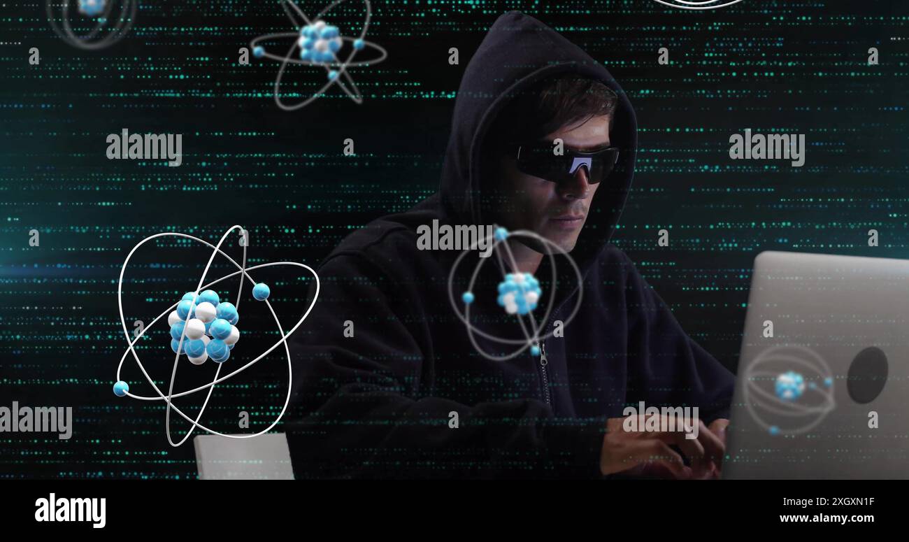 Image of atom structures over biracial male hacker using laptop to hack ...