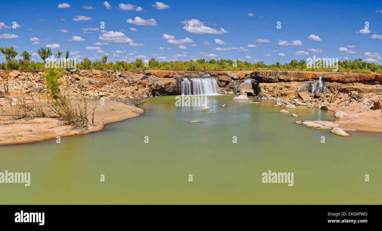 Panorama of Leichhardt Falls plunge waterfall over red rock escarpment ...