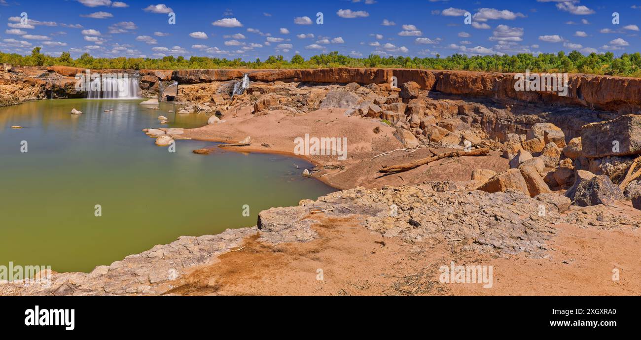 Panorama of Leichhardt Falls plunge waterfall over red rock escarpment ...
