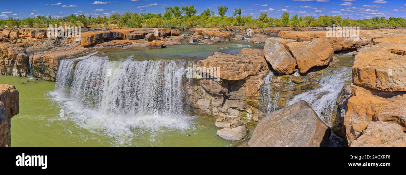 Panorama of Leichhardt Falls plunge waterfall over red rock escarpment ...