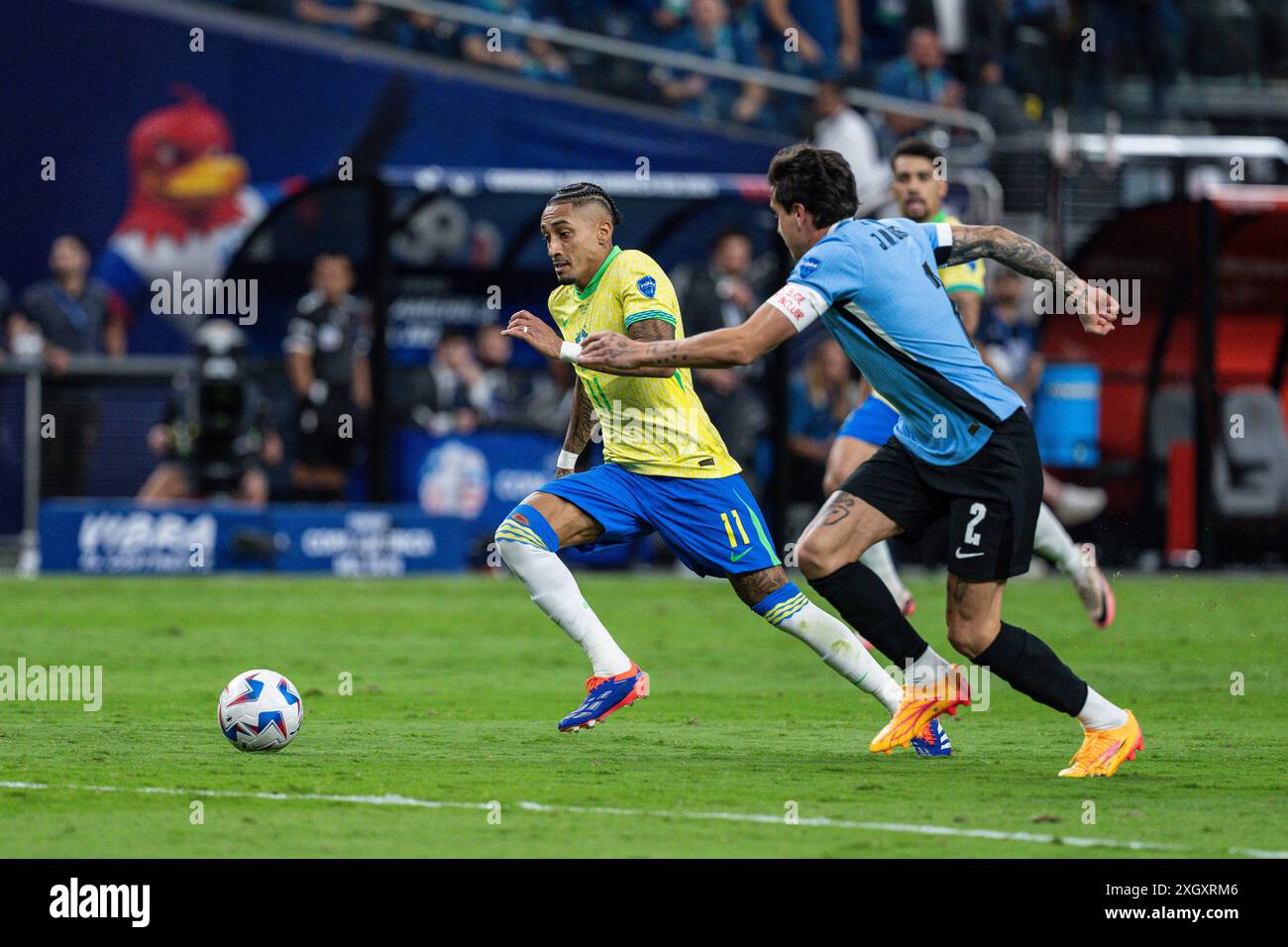 Brazil midfielder Raphinha (11) is defended by Uruguay defender José ...