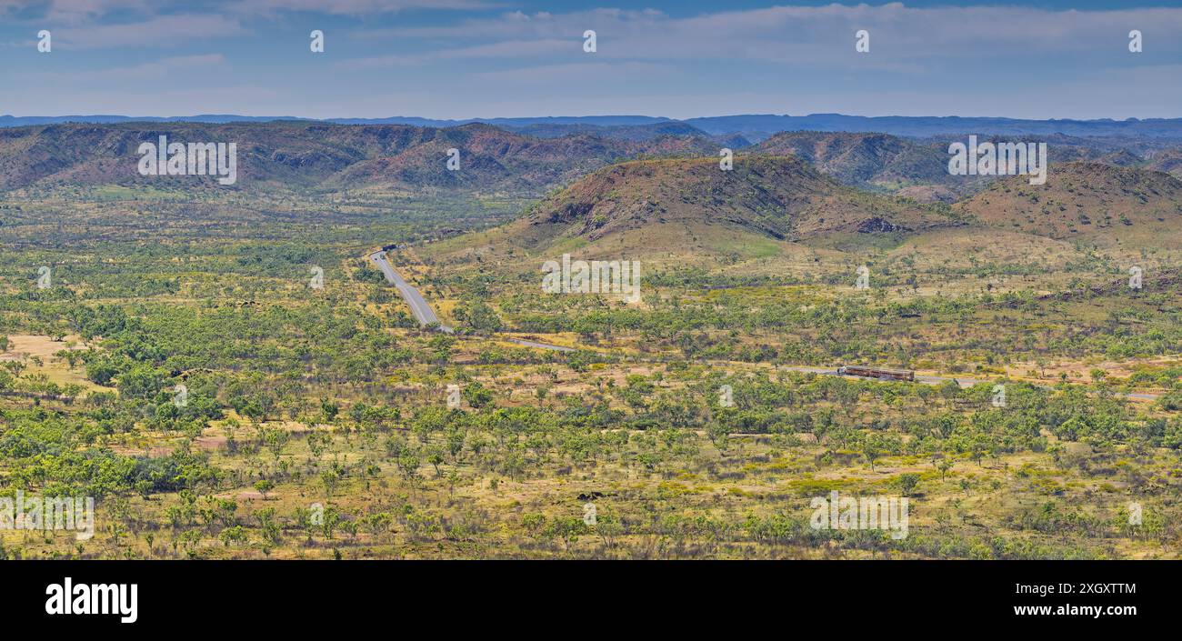Remote outback road Barkly highway cutting through low mountain ranges ...