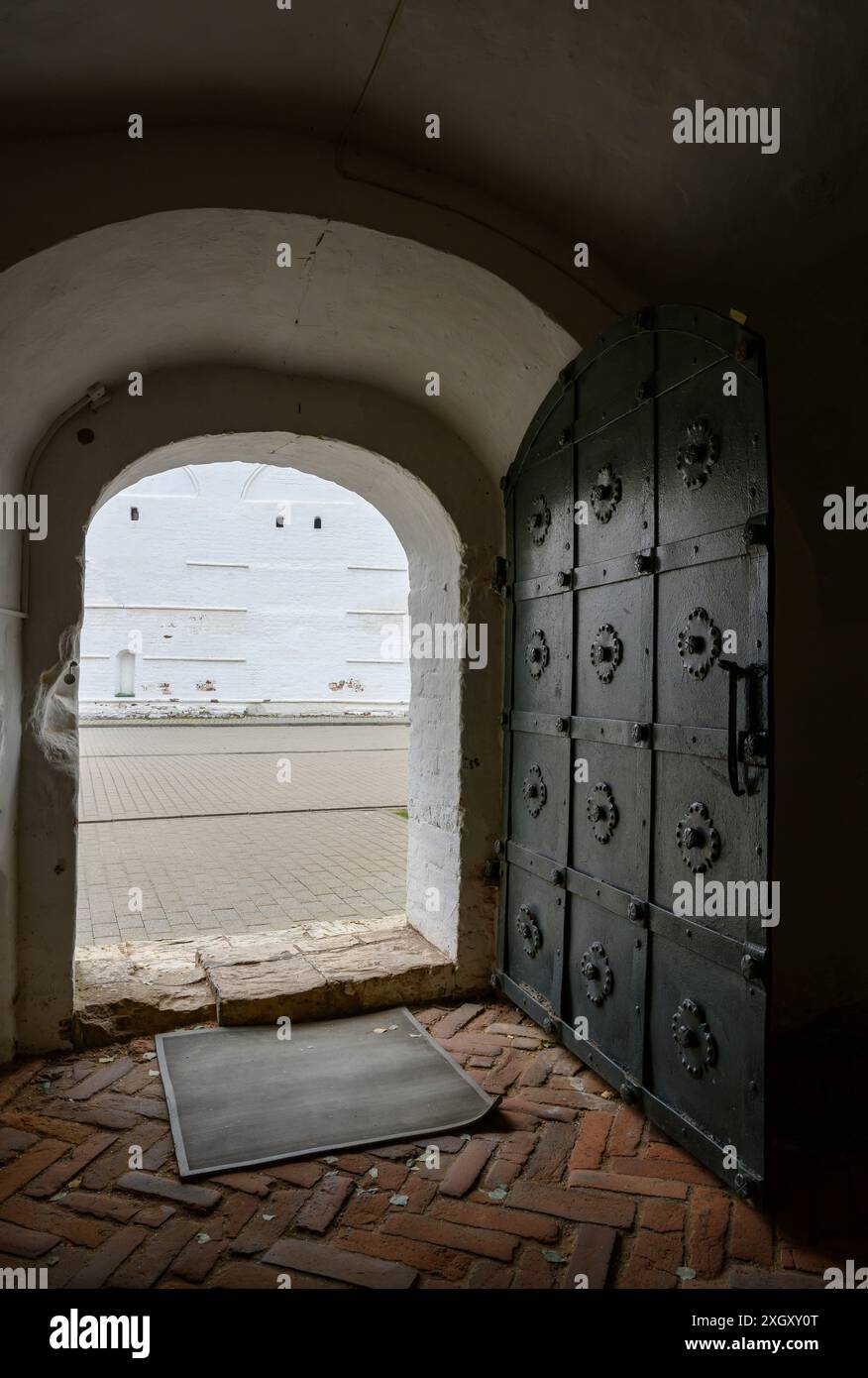 Exit to the courtyard of a medieval monastery with an arched corridor ...