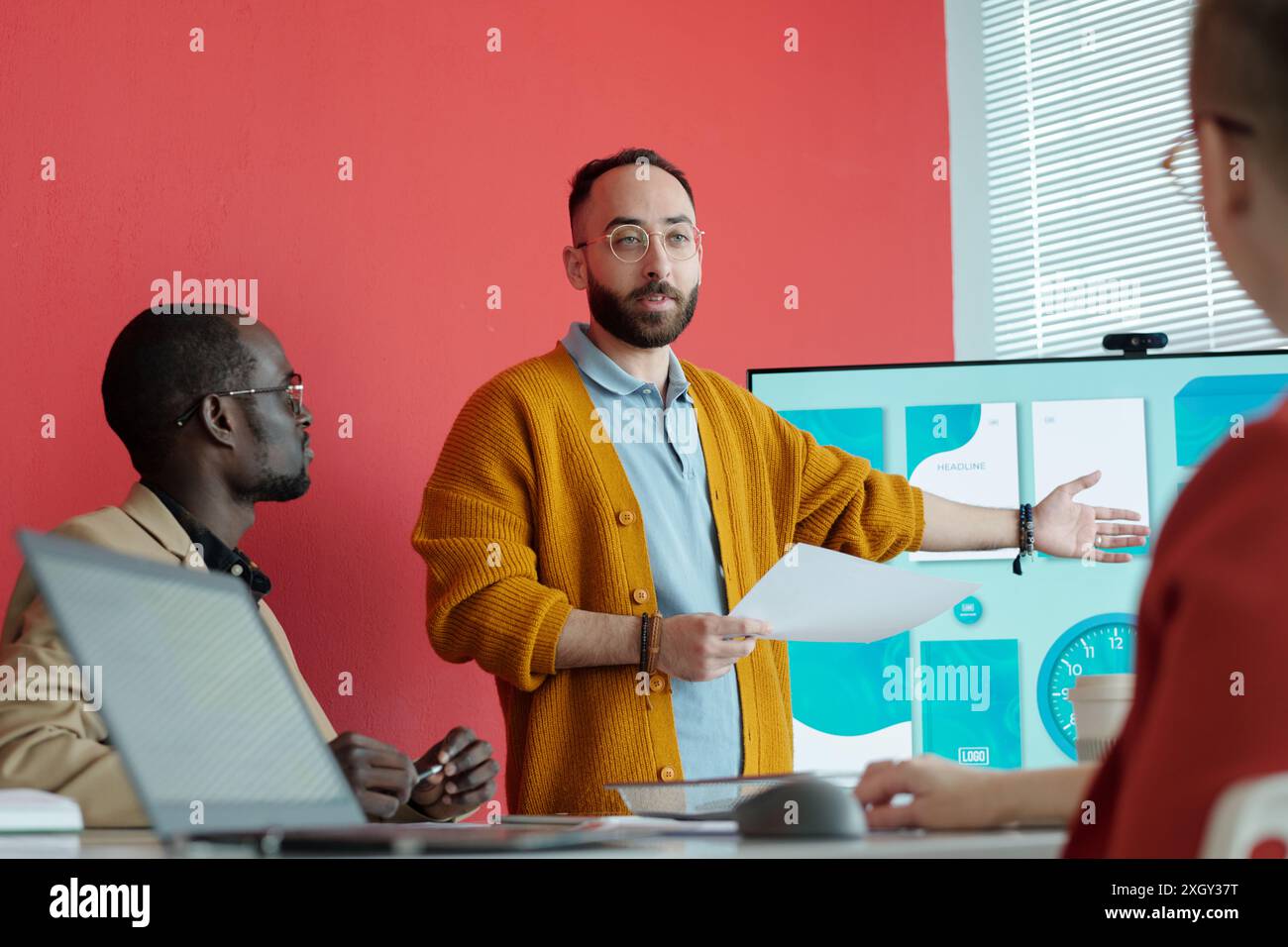 Man presenting new business strategy to colleagues in modern office ...