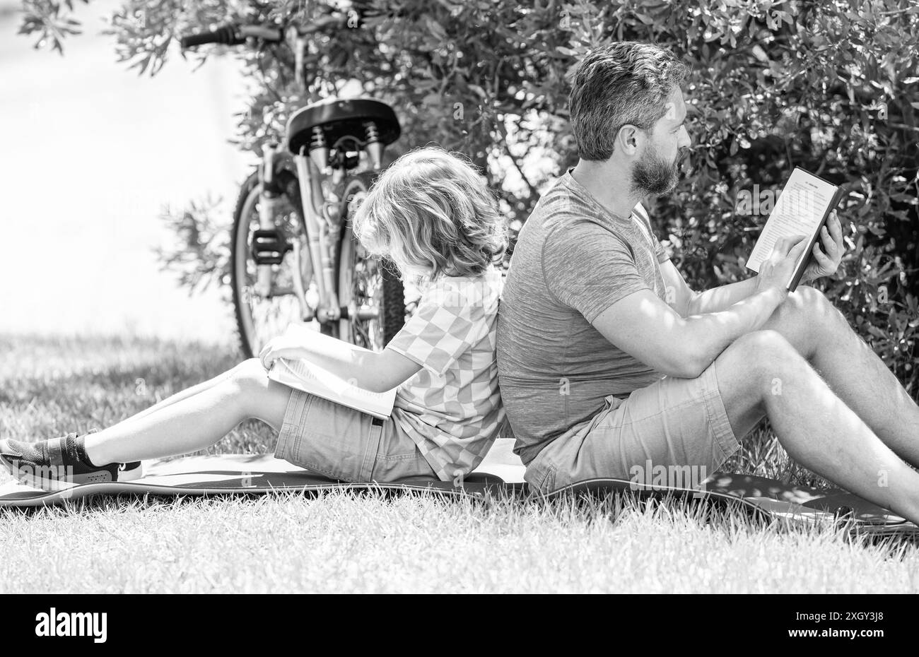 Father and son bonding through outdoor reading. Father and son reading ...