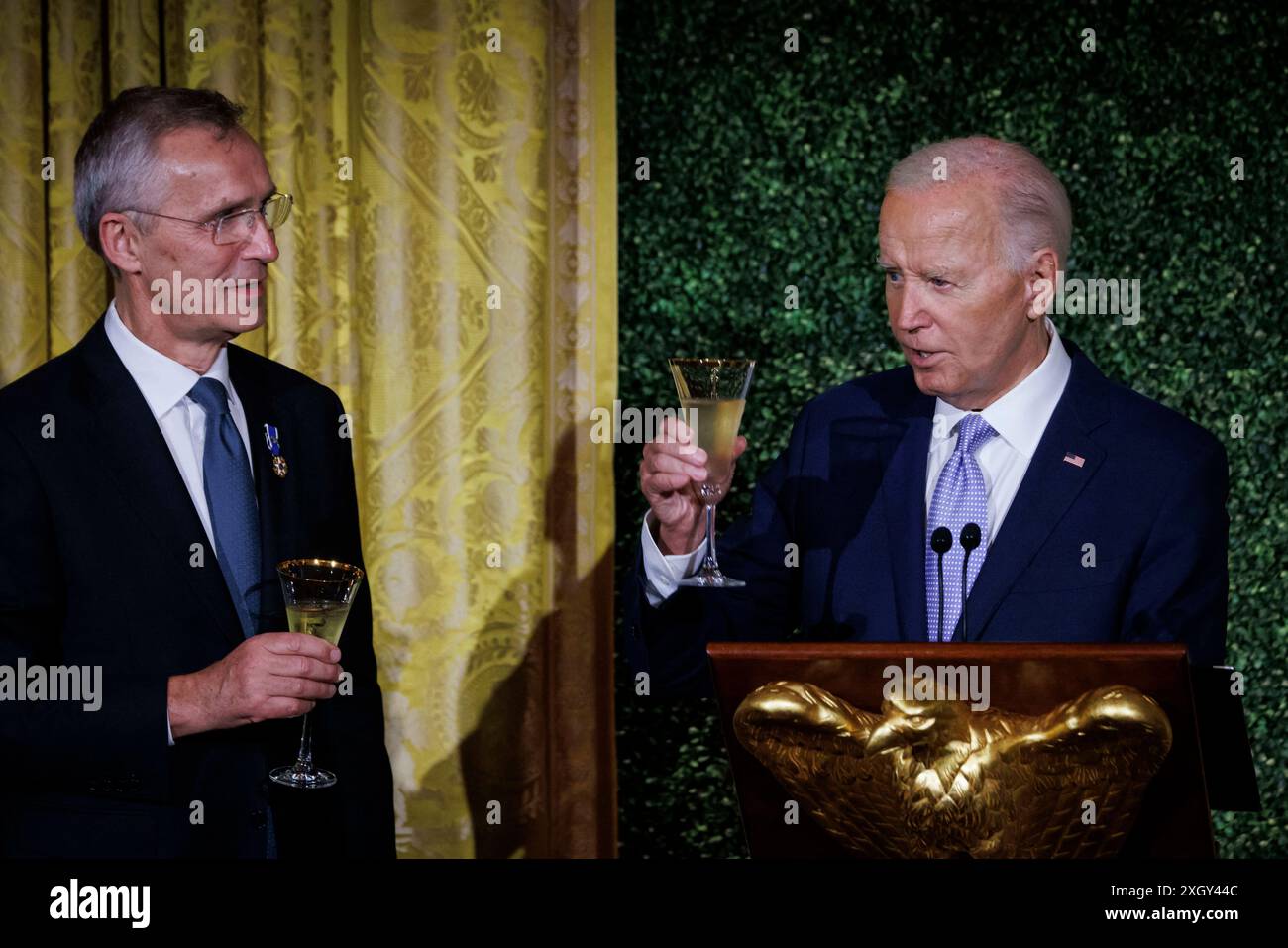 US President Joe Biden toasts during a dinner with NATO allies and ...