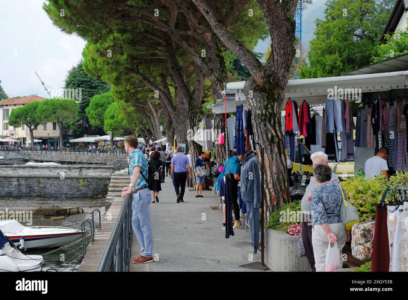 Market day on the promenade at Lenno on Lake Como, Italy. An avenue of ...
