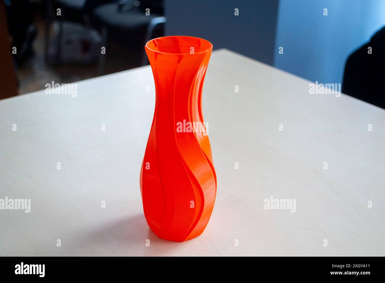Object in the form of a vase of red color printed on a 3D printer ...