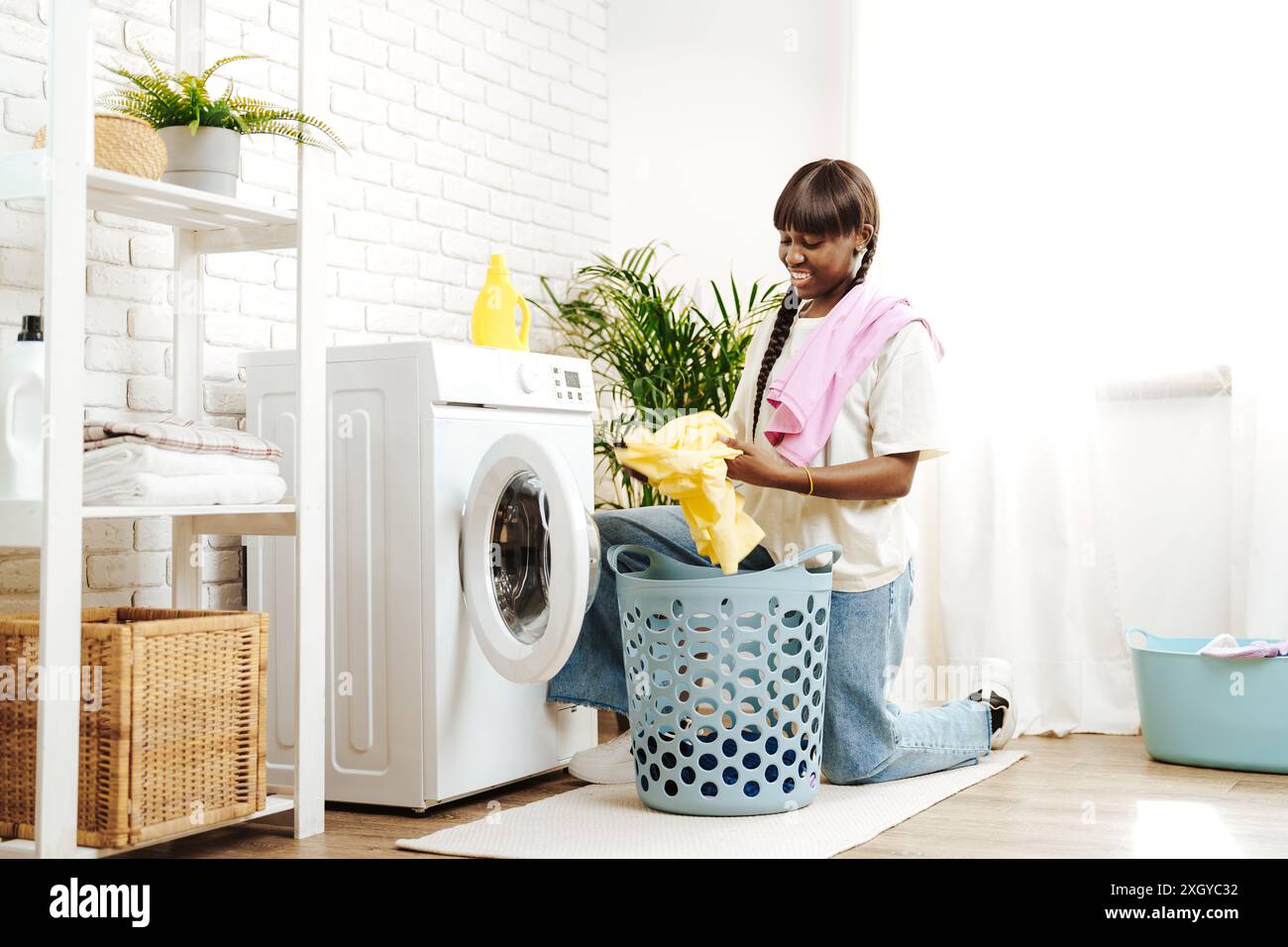 African Woman Folding Laundry After Washing Clothes in Modern Laundry ...