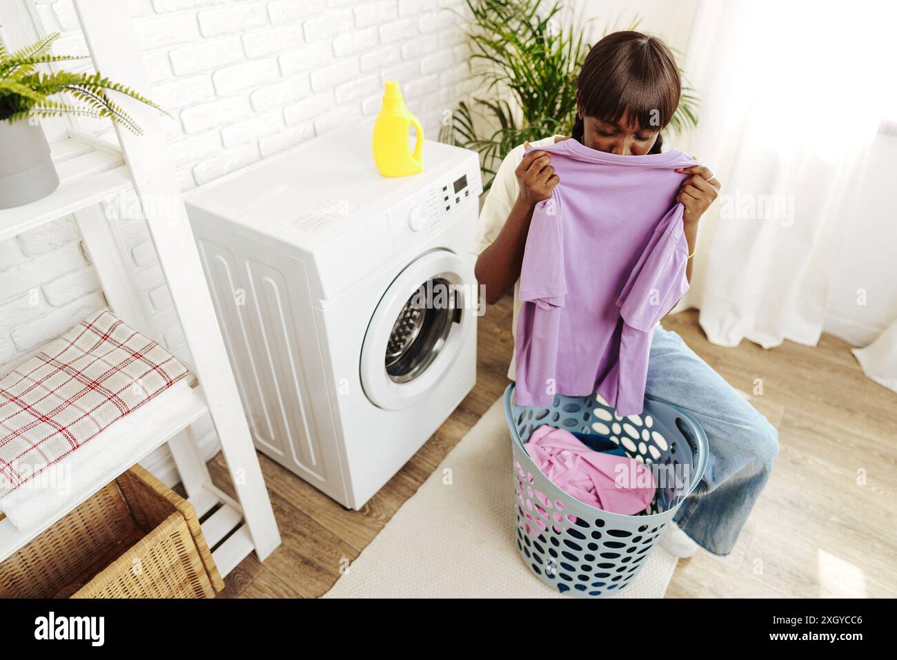 African Woman Checking Laundry After Washing Machine Cycle Stock Photo ...