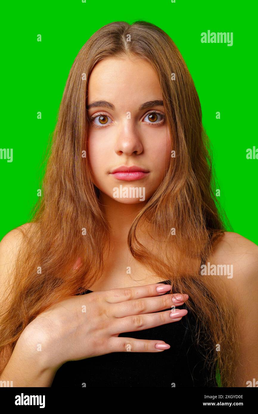 Young Woman Making a Surprised Face in Front of Green Screen Stock Photo - Alamy