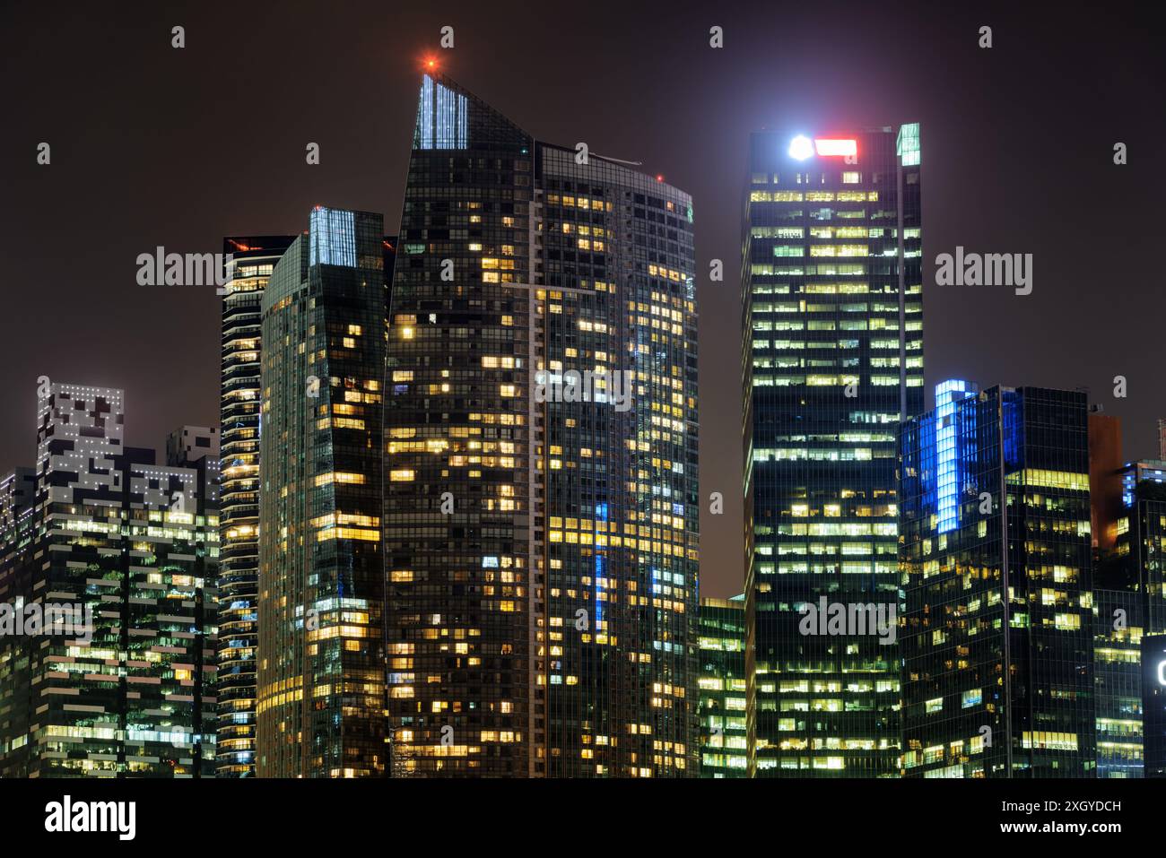 Amazing glowing windows of skyscrapers at evening. View of modern ...