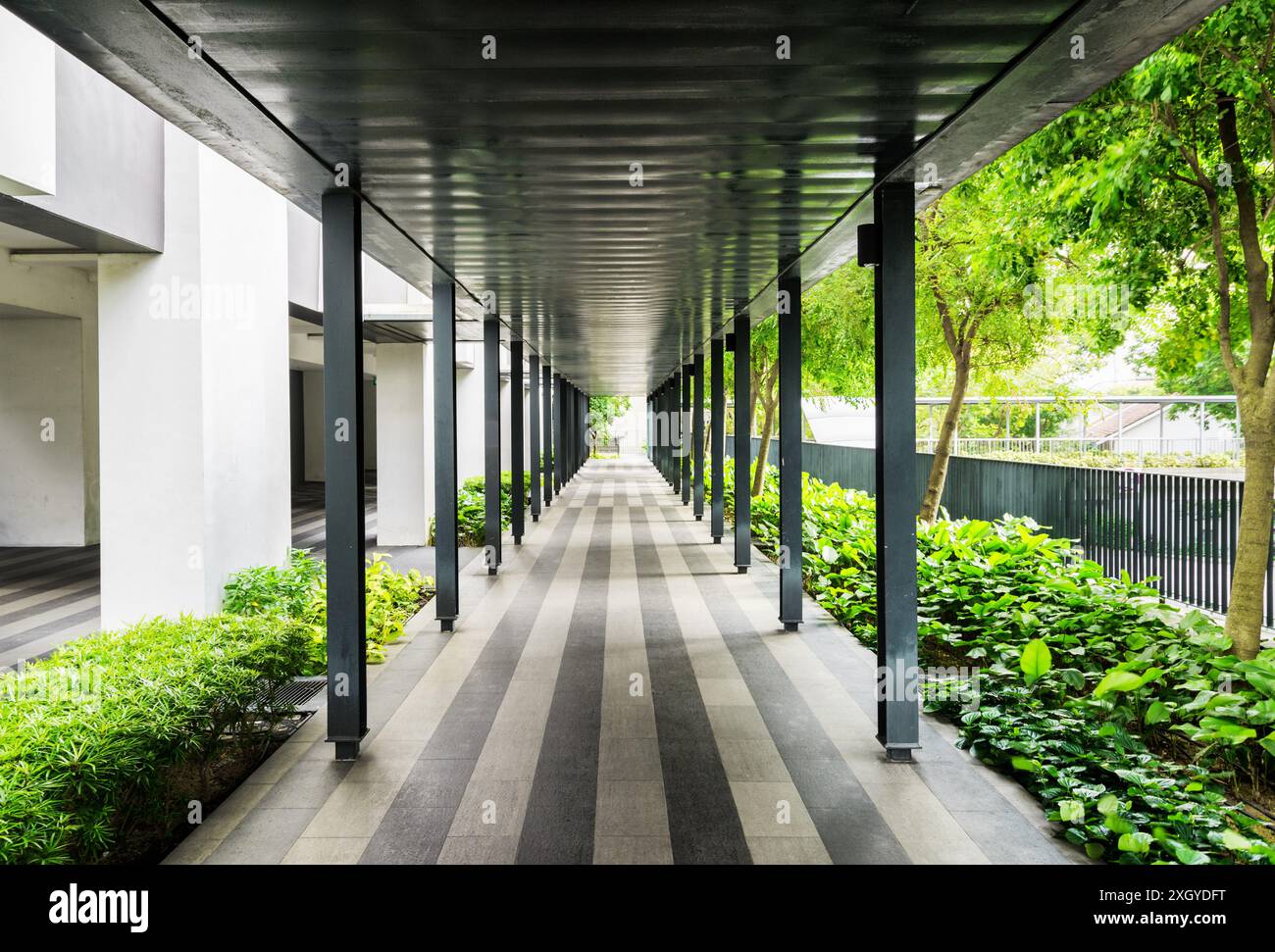 Modern open corridor protecting from the sun and rain. Outside walkway along a building Stock ...