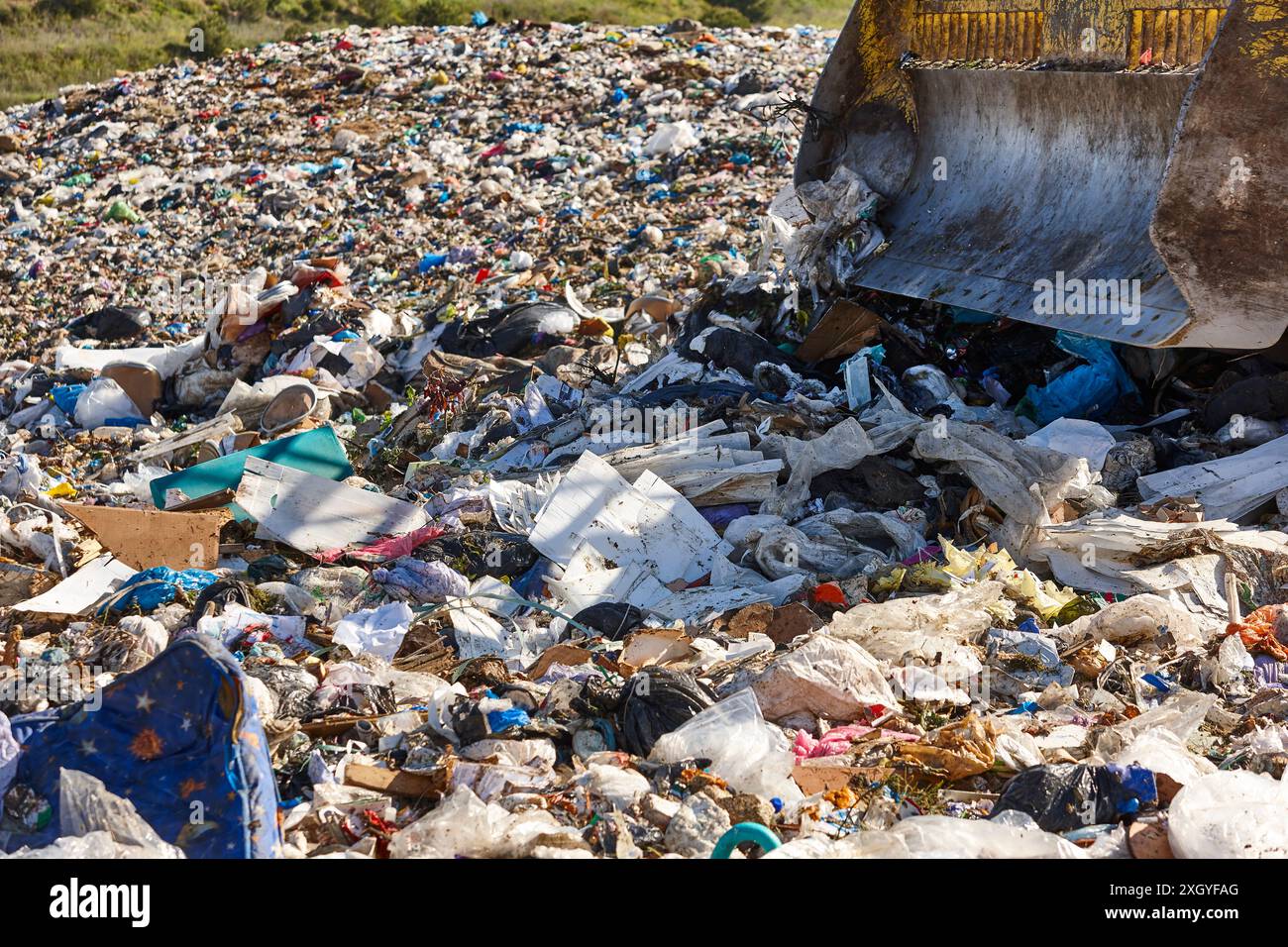 Heavy machinery shredding garbage in an open air landfill. Waste Stock ...