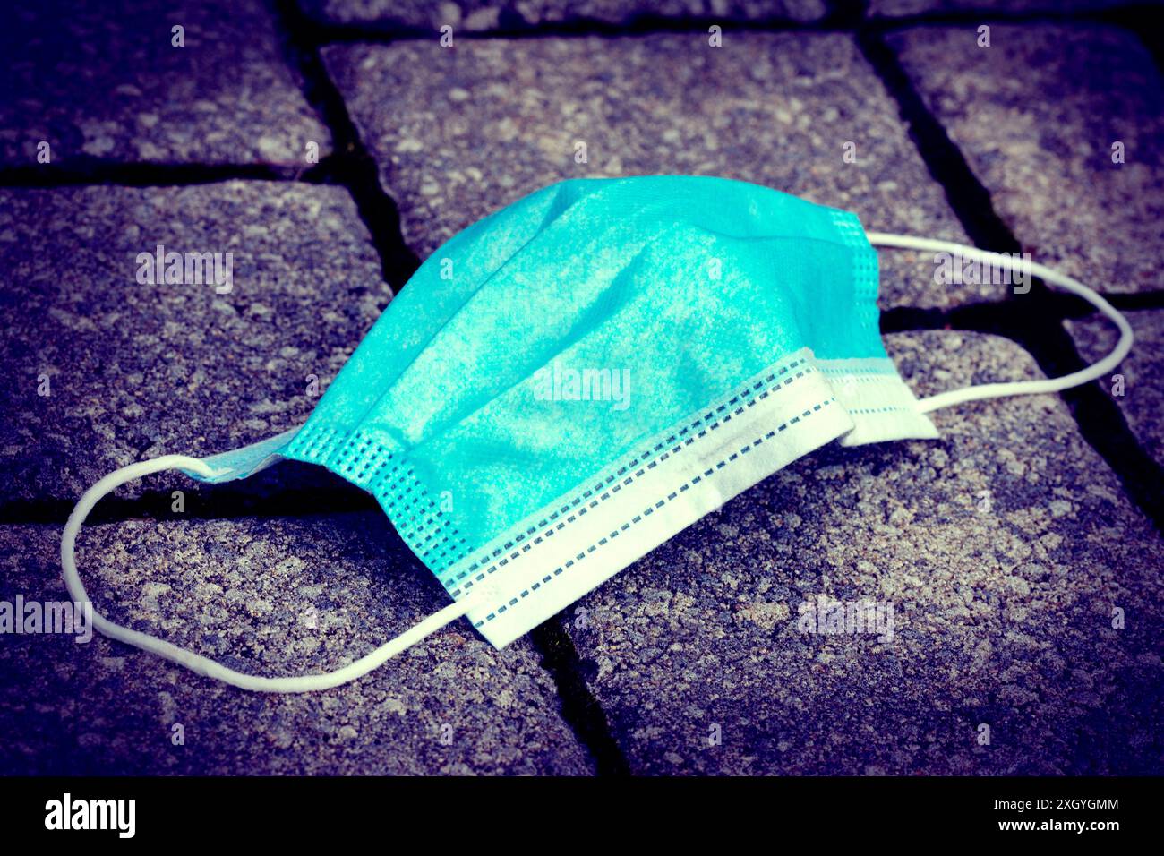 Used mask lies on the sidewalk Stock Photo - Alamy