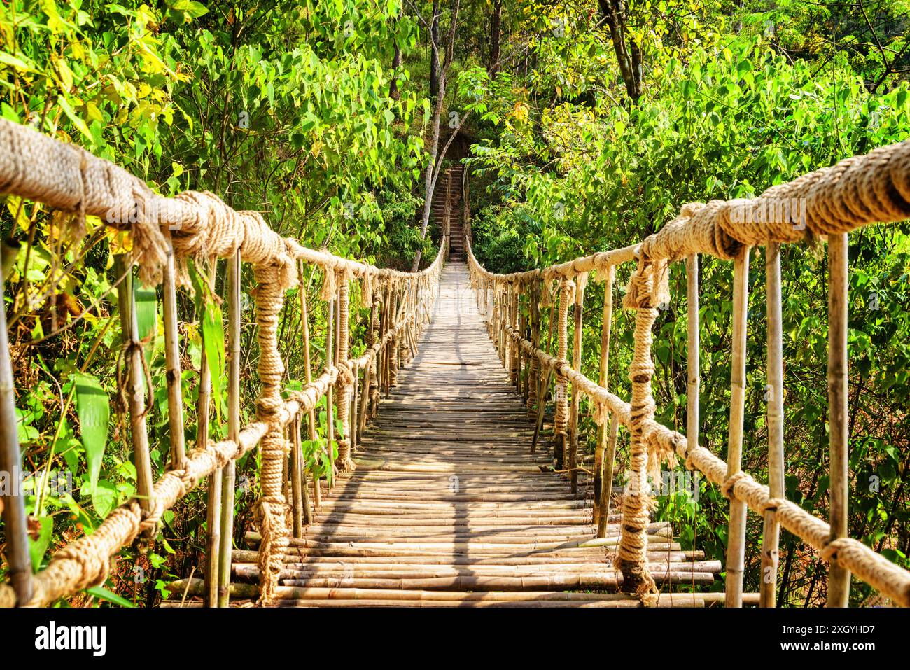 Scenic simple suspension bridge over gorge. Amazing footbridge made ...
