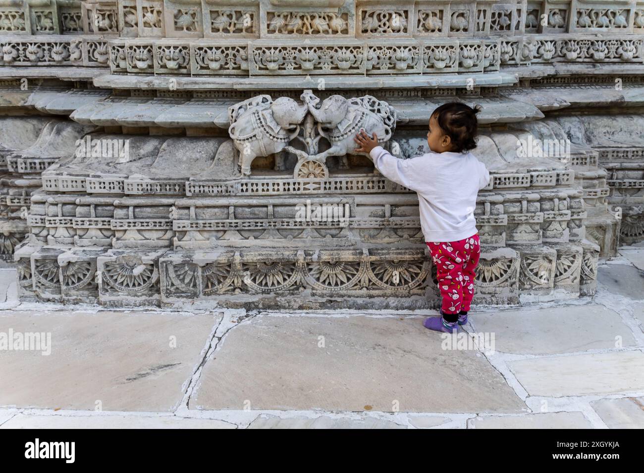 cute kid touching ancient temple wall exterior unique art from ...