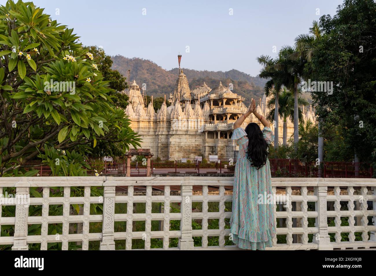 young girl praying at ancient unique temple with bright sky at day from ...
