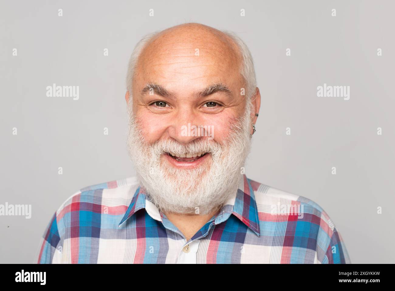 Happy old mature man smiling. Closeup portrait of an elegant senior man with grey beard isolated ...