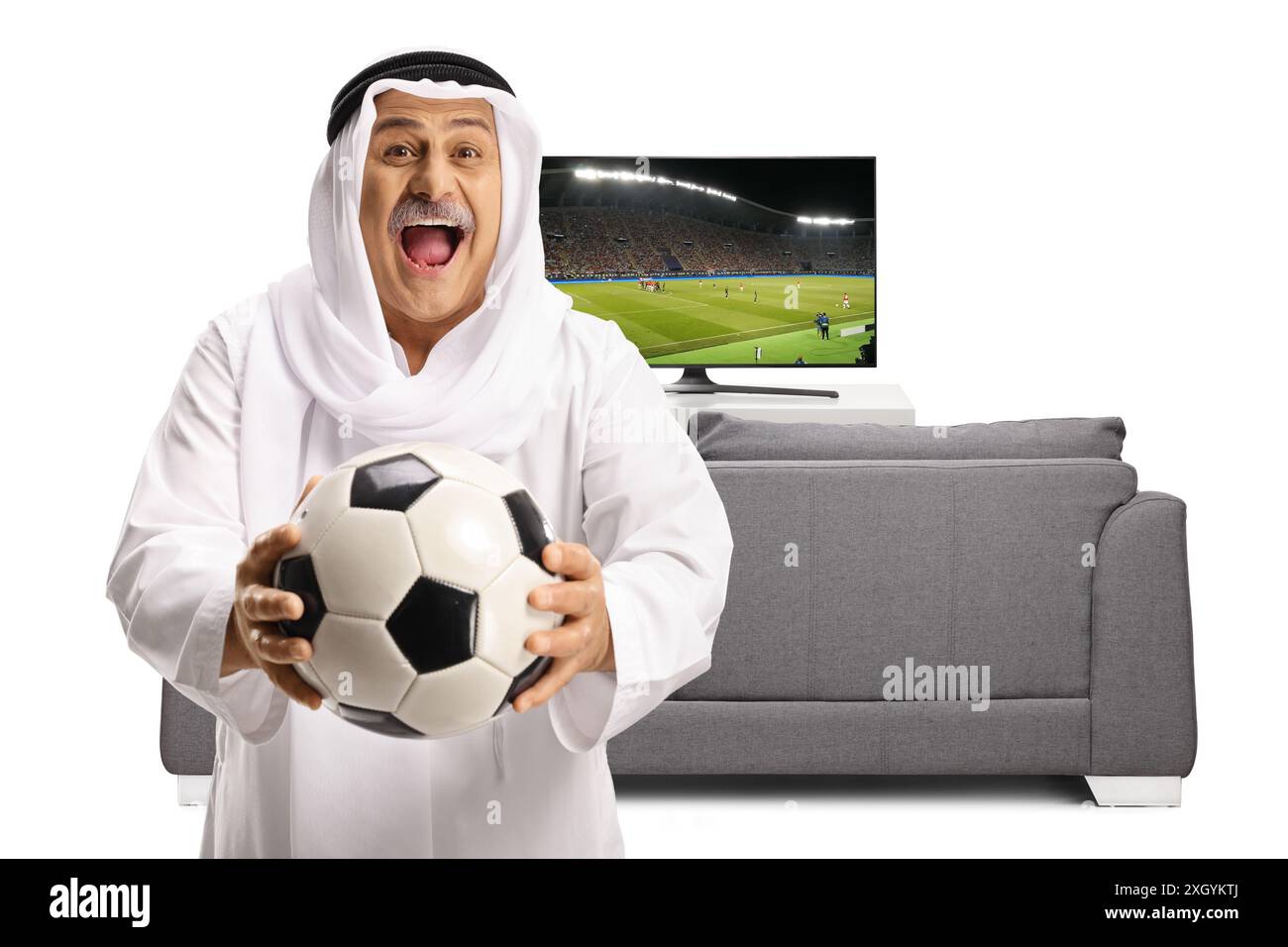 Excited mature muslim man holding a football in front of tv screen ...