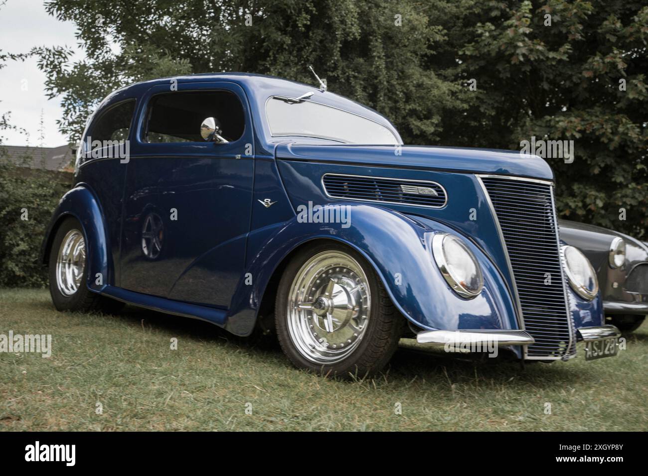 Side view of a blue restored 1955 Ford Popular hot rod, on display at ...
